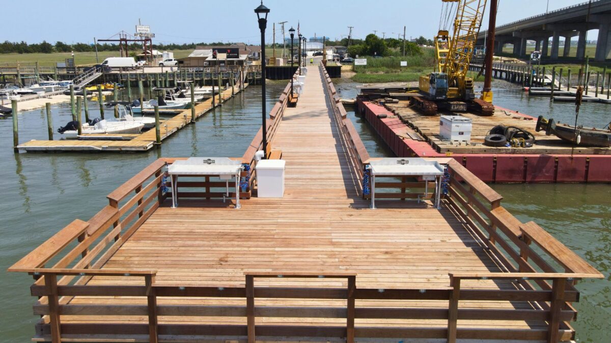 Wooden pier overlooking marina with boats. - Wildwood Video Archive