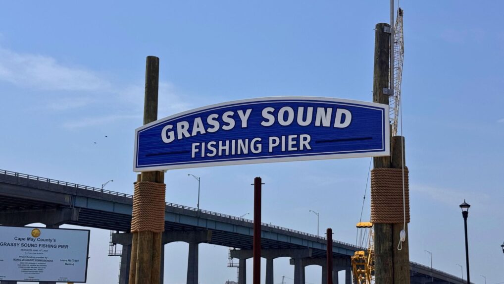 Grassy Sound Fishing Pier sign with bridge. - Wildwood Video Archive